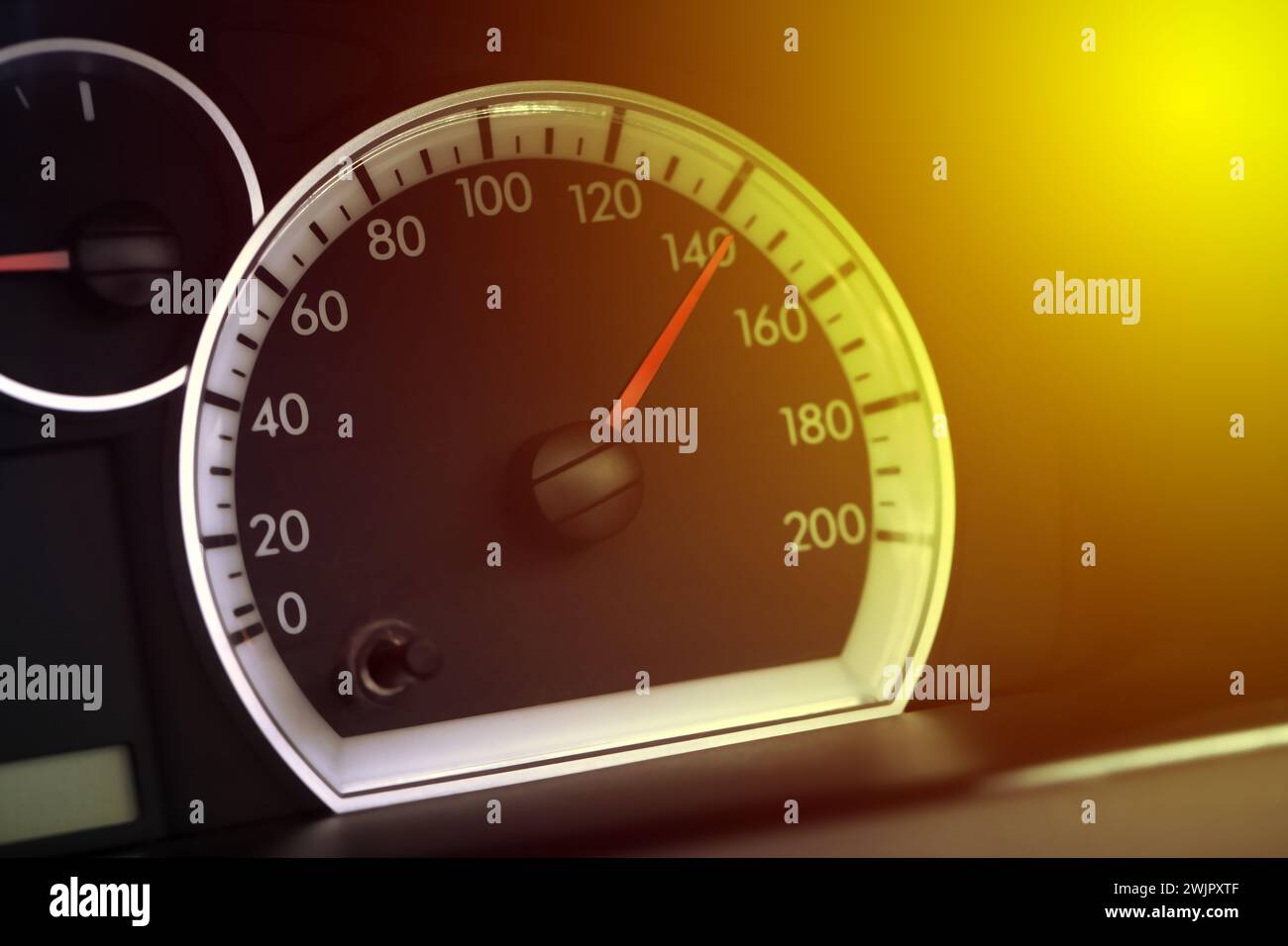 Speedometer on car dashboard under yellow light, closeup Stock Photo ...