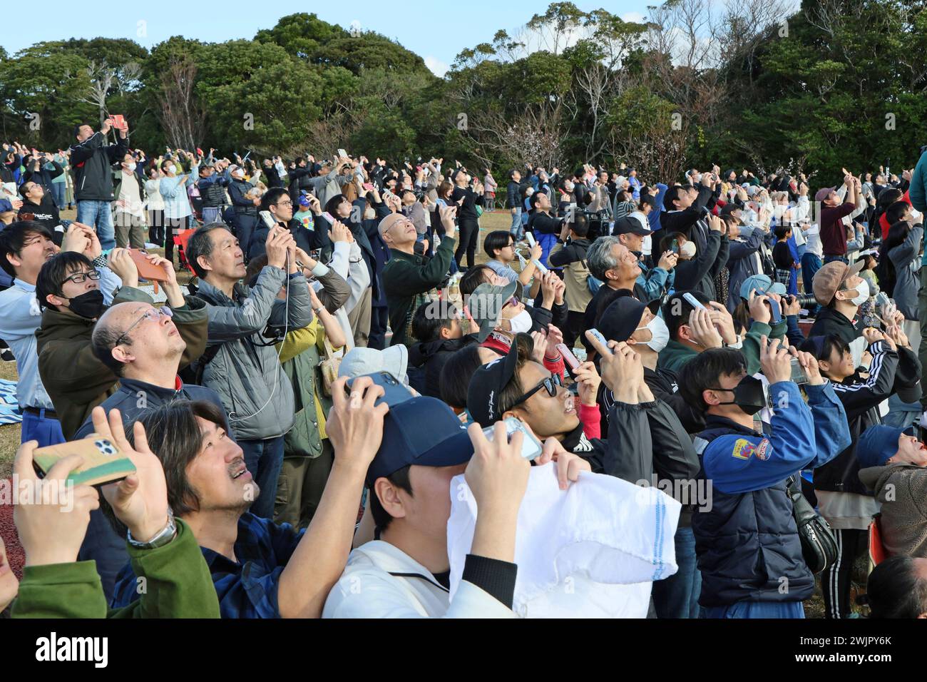People watch Japan Aerospace Exploration Agency (JAXA) launcheing the ...