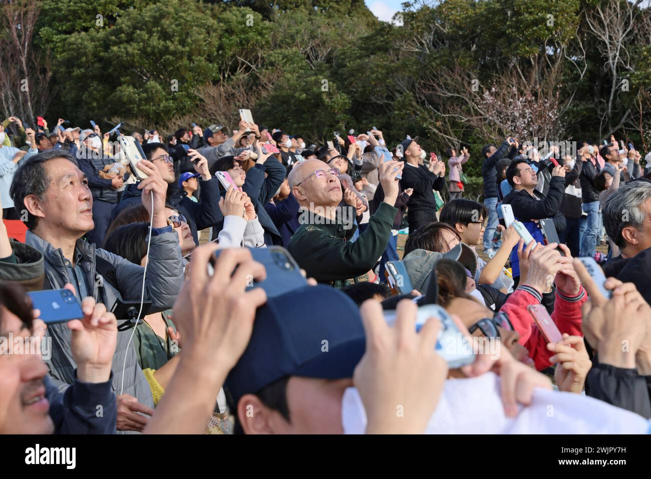 People watch Japan Aerospace Exploration Agency (JAXA) launcheing the ...