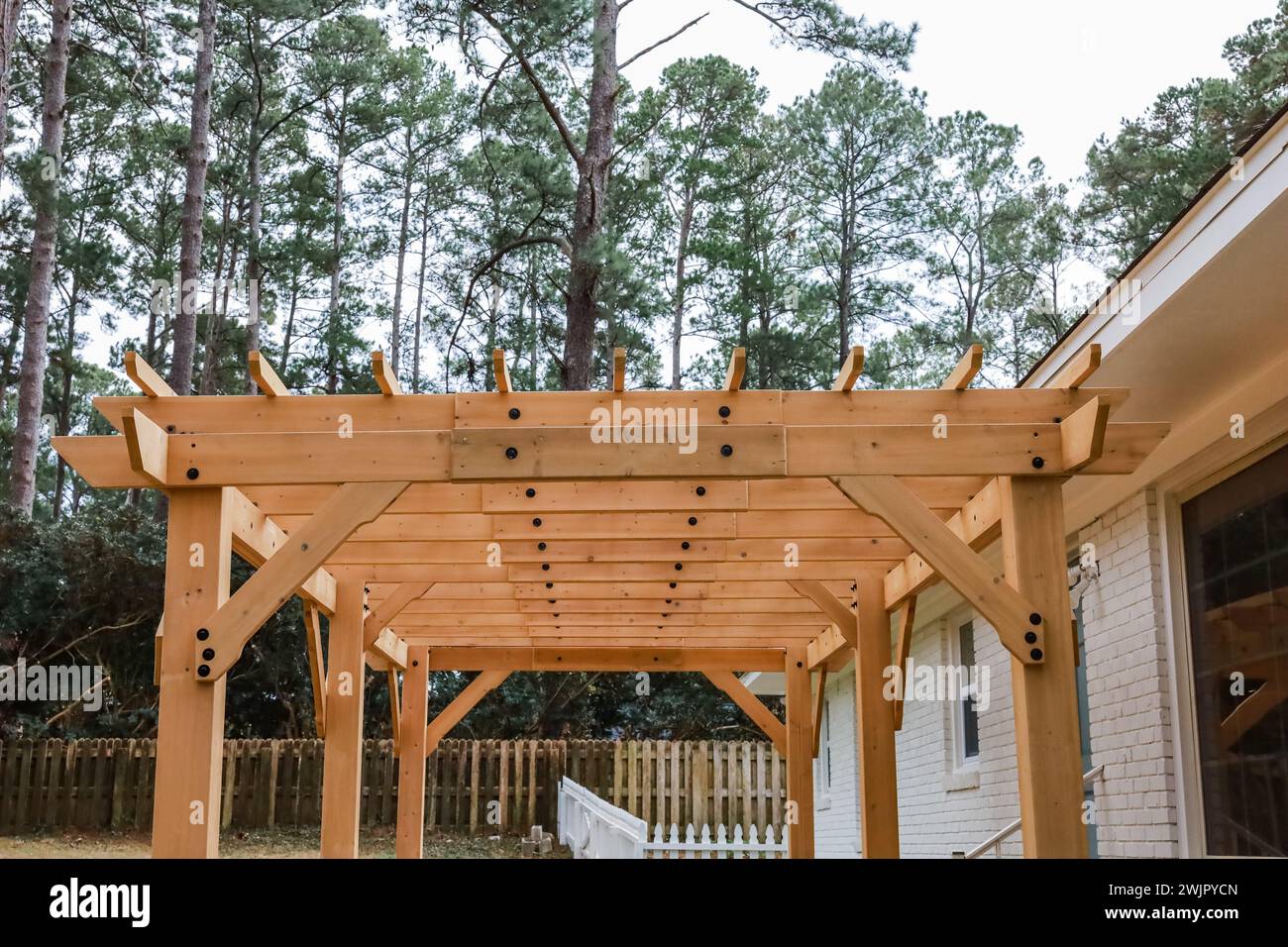 The rear back exterior of a newly painted and renovated white brick ...