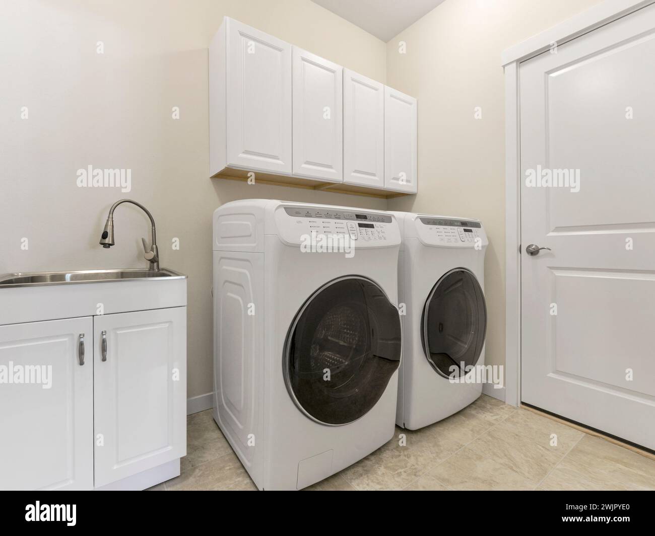 Modern residential laundry room interior Stock Photo - Alamy