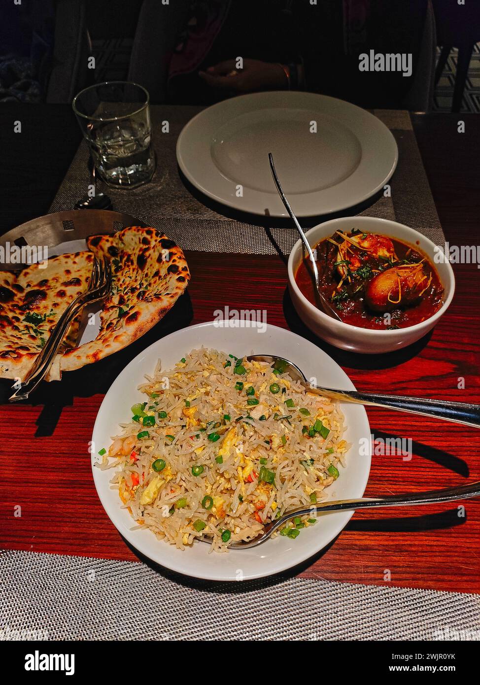 mixed fried rice served alongwith cheese naan and non veg cuisine in an ...