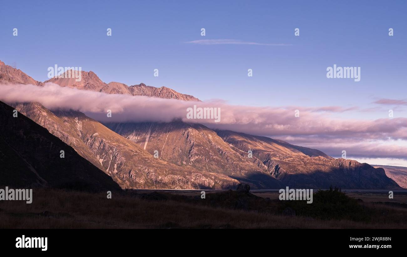 Gorgeous Sunset Glow: Mountain Peak Awash in Warm Light Amidst Stunning ...