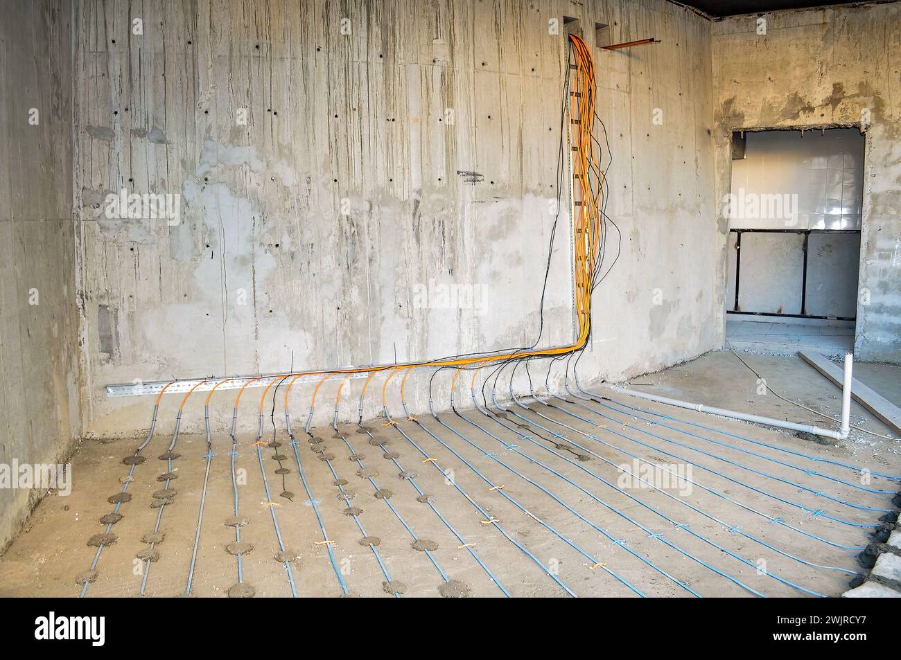 The stage of installation of a cable for a warm floor on concrete, a ...