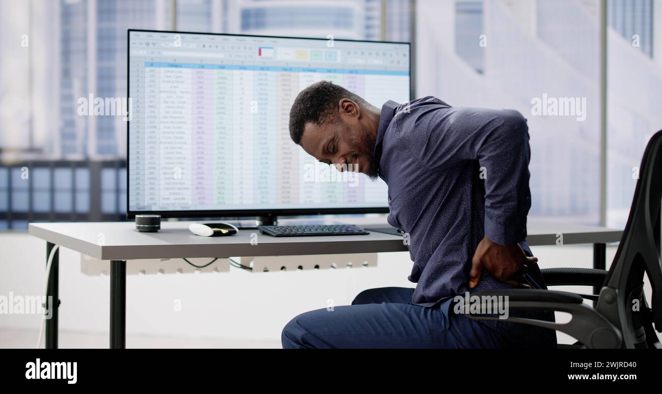 Back Pain Bad Posture Man Sitting In Office Stock Photo - Alamy