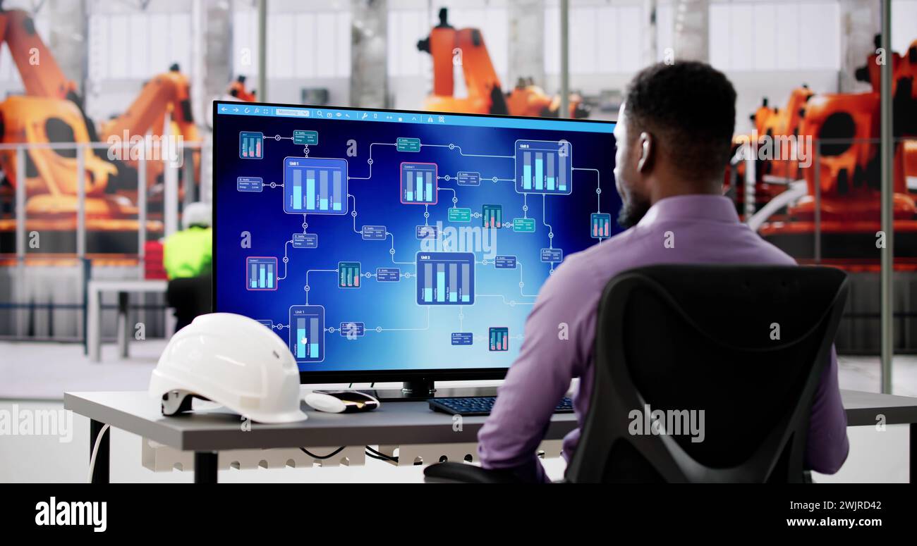 African American Engineer Using Computer In Electric Car Assembly ...
