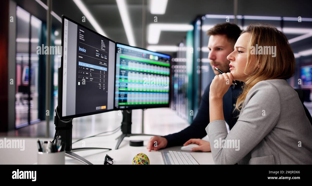 Accountants Looking At Invoice Spreadsheet On Computer Monitor Stock ...
