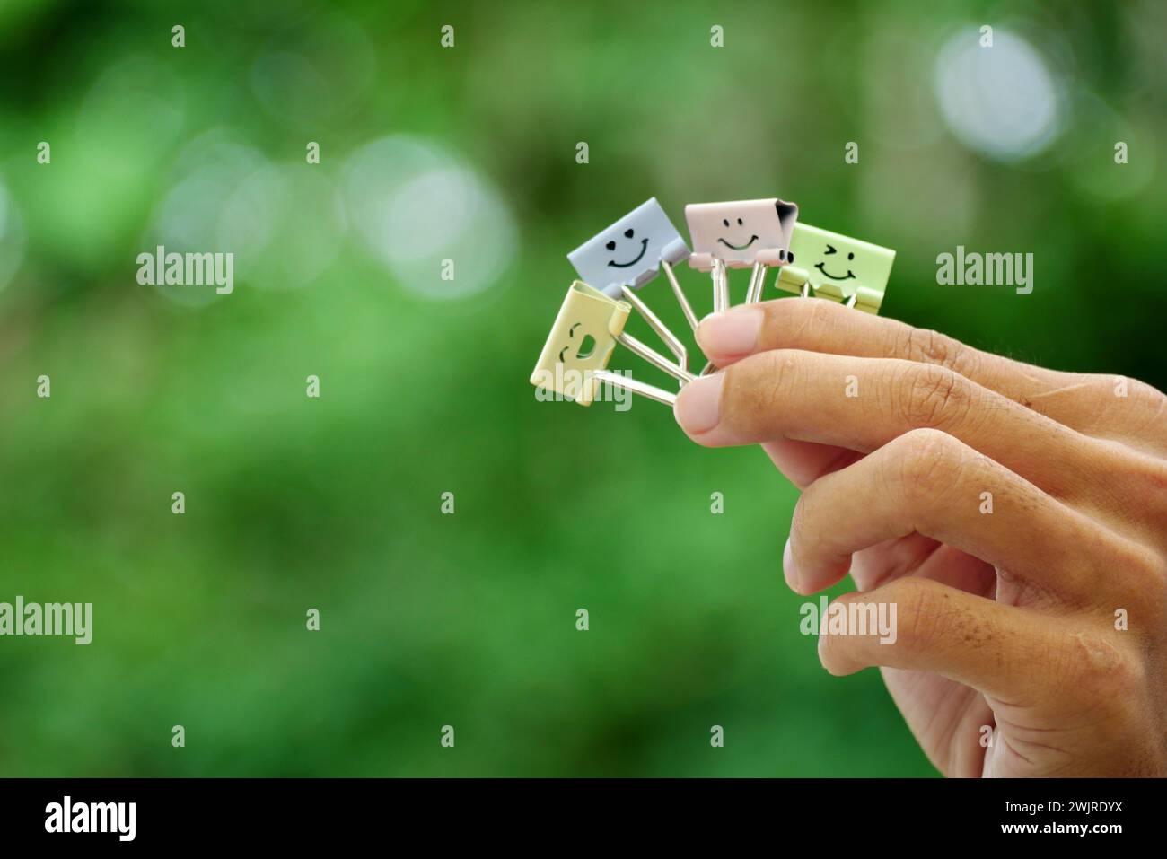 Happy emoticon paperclip on finger. Concept of positive thinking ...