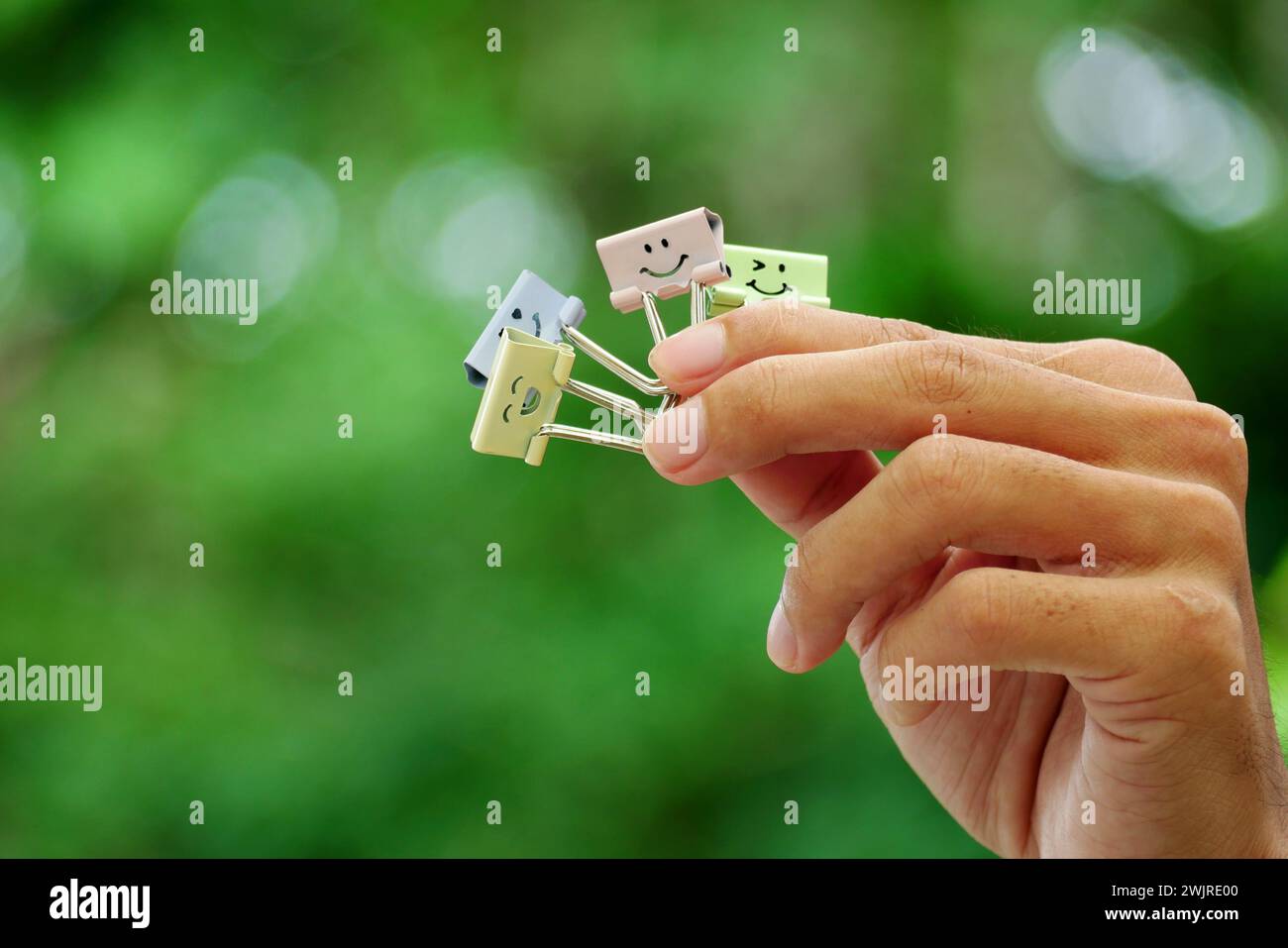 Happy emoticon paperclip on finger. Concept of positive thinking ...