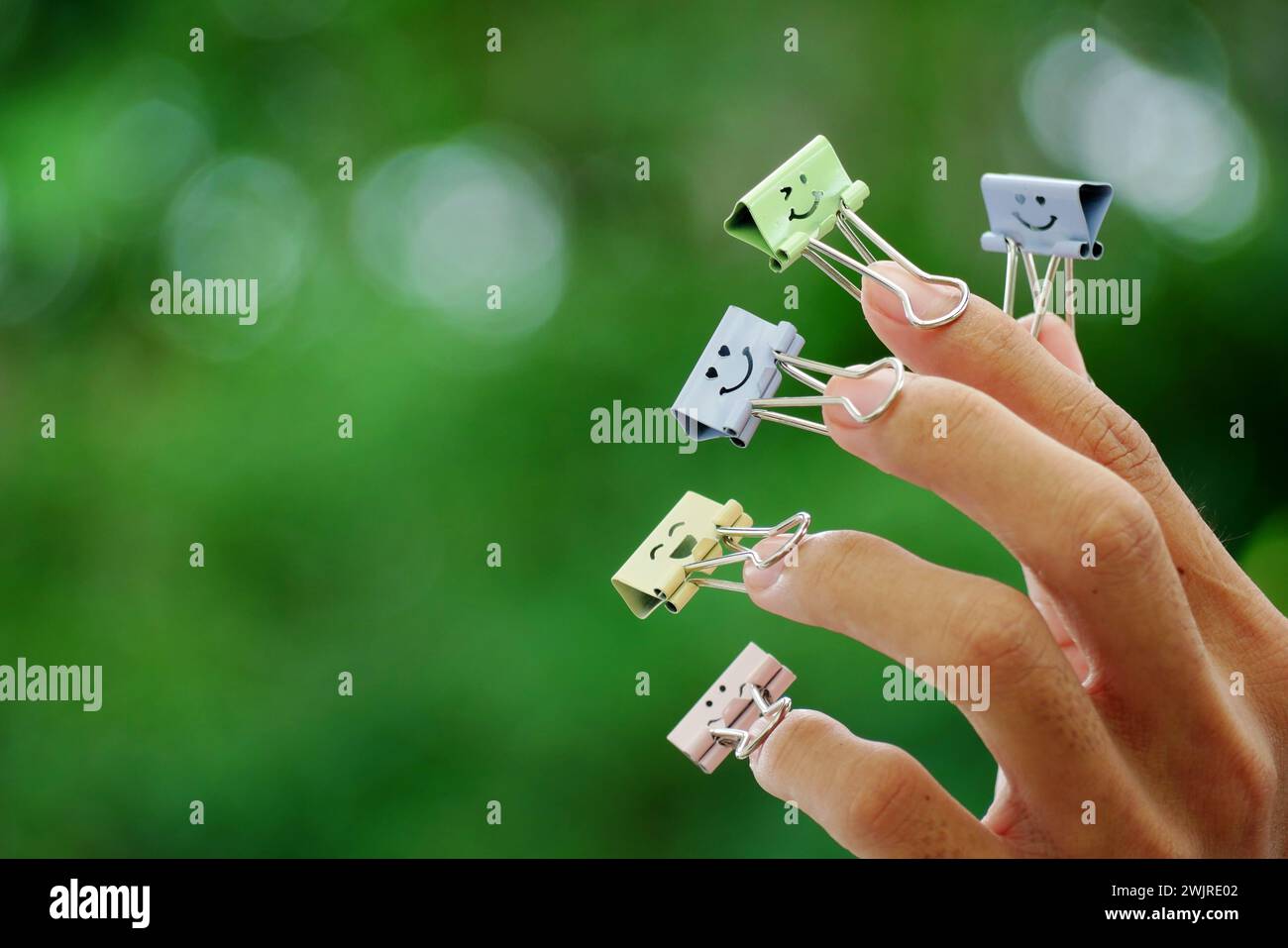 Happy emoticon paperclip on finger. Concept of positive thinking ...