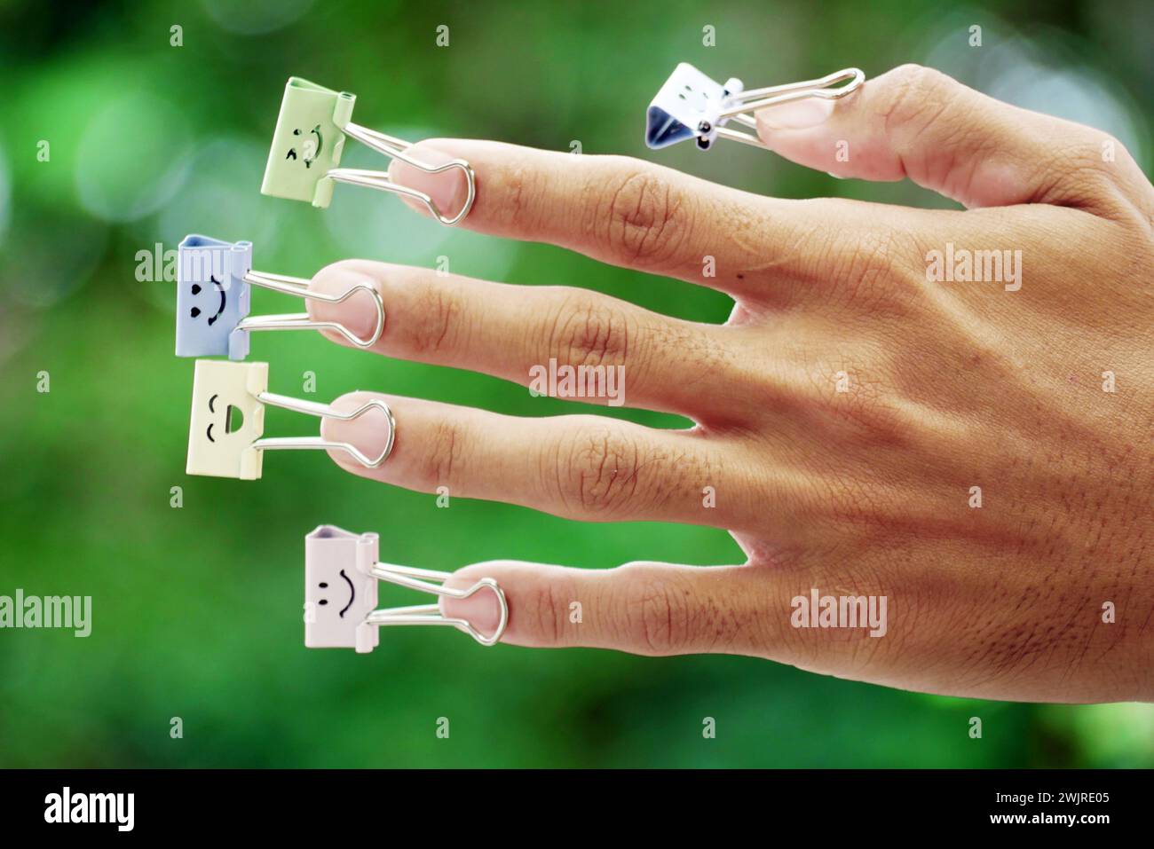 Happy emoticon paperclip on finger. Concept of positive thinking ...