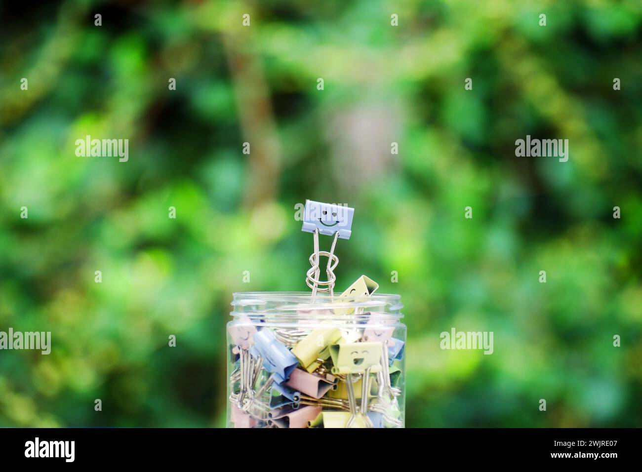 Happy emoticon paperclip on finger. Concept of positive thinking ...