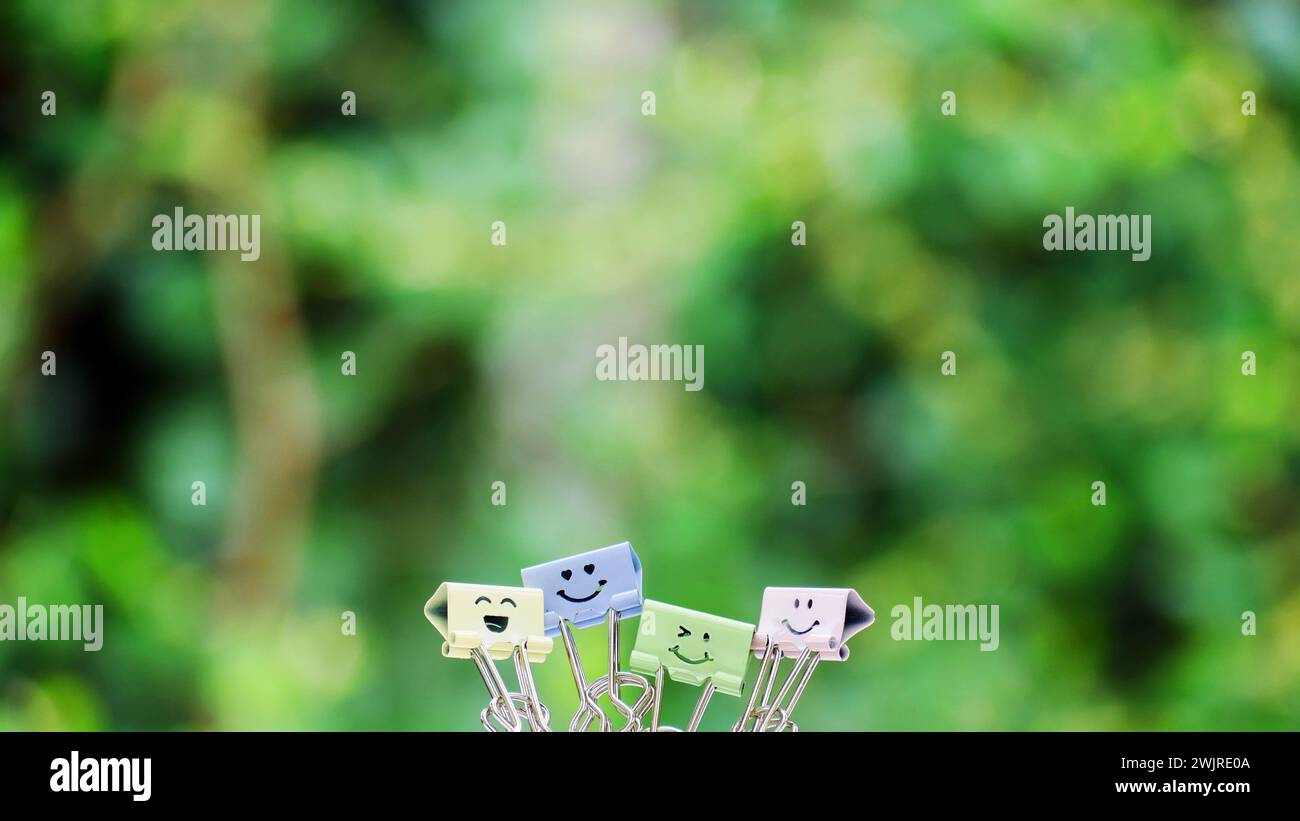 Happy emoticon paperclip on finger. Concept of positive thinking ...