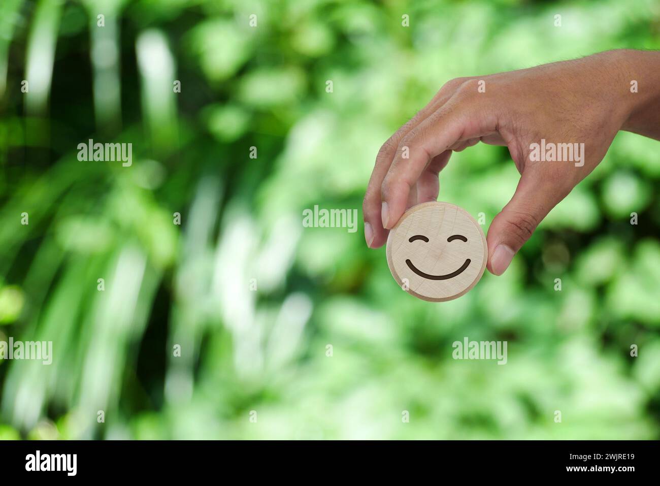Hand holding wood happy smile face. Concept of positive thinking ...