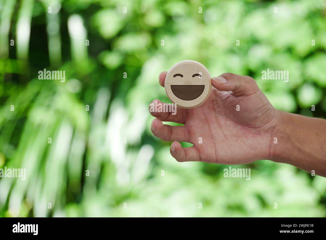 Hand holding wood happy smile face. Concept of positive thinking ...