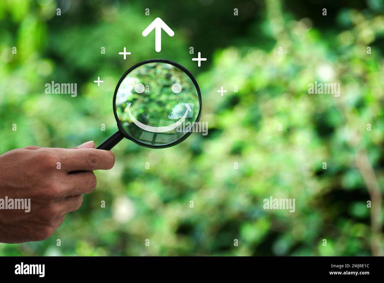 Hand holding a magnifying glass highlighting a happy smile. Concept of ...