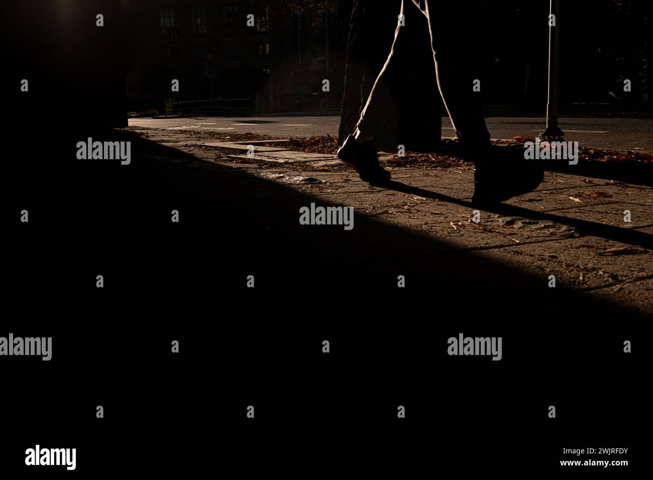 A man walking on the street in sunlight Stock Photo - Alamy