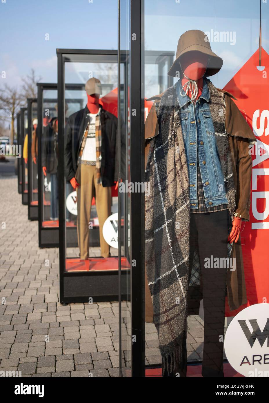 Row of mannequins in display windows at “Vicolungo the Style Outlets ...