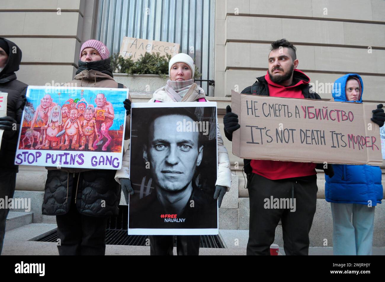 Demonstrators hold placards expressing their opinions of Alexei Navalny ...