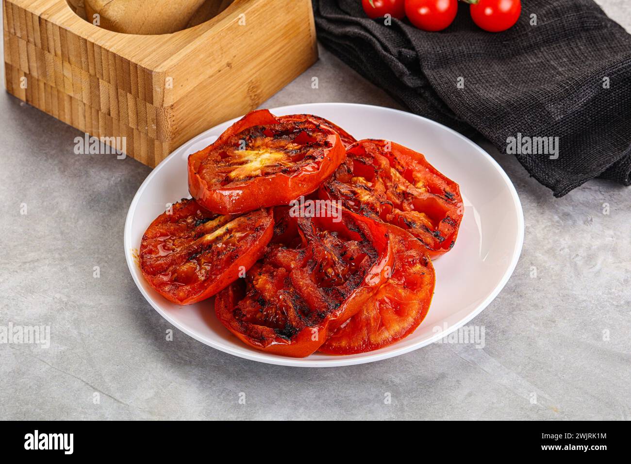 Vegan cuisine - Griiled ripe red tomatoes snack Stock Photo - Alamy