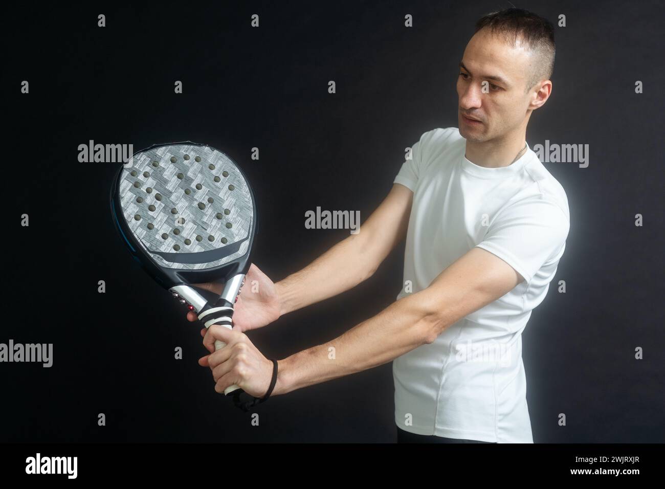 Padel Tennis Player with Racket in Hands. Paddle tennis, on a black ...