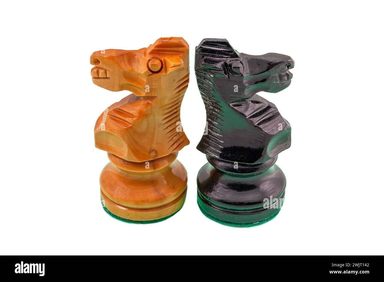 Two chess knights, black and white, turn their backs to each other ...