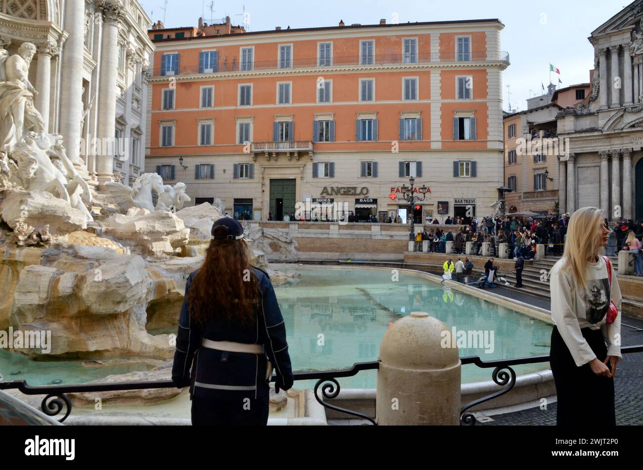 men collecting the money thrown into the trevi fountain rome capital of ...