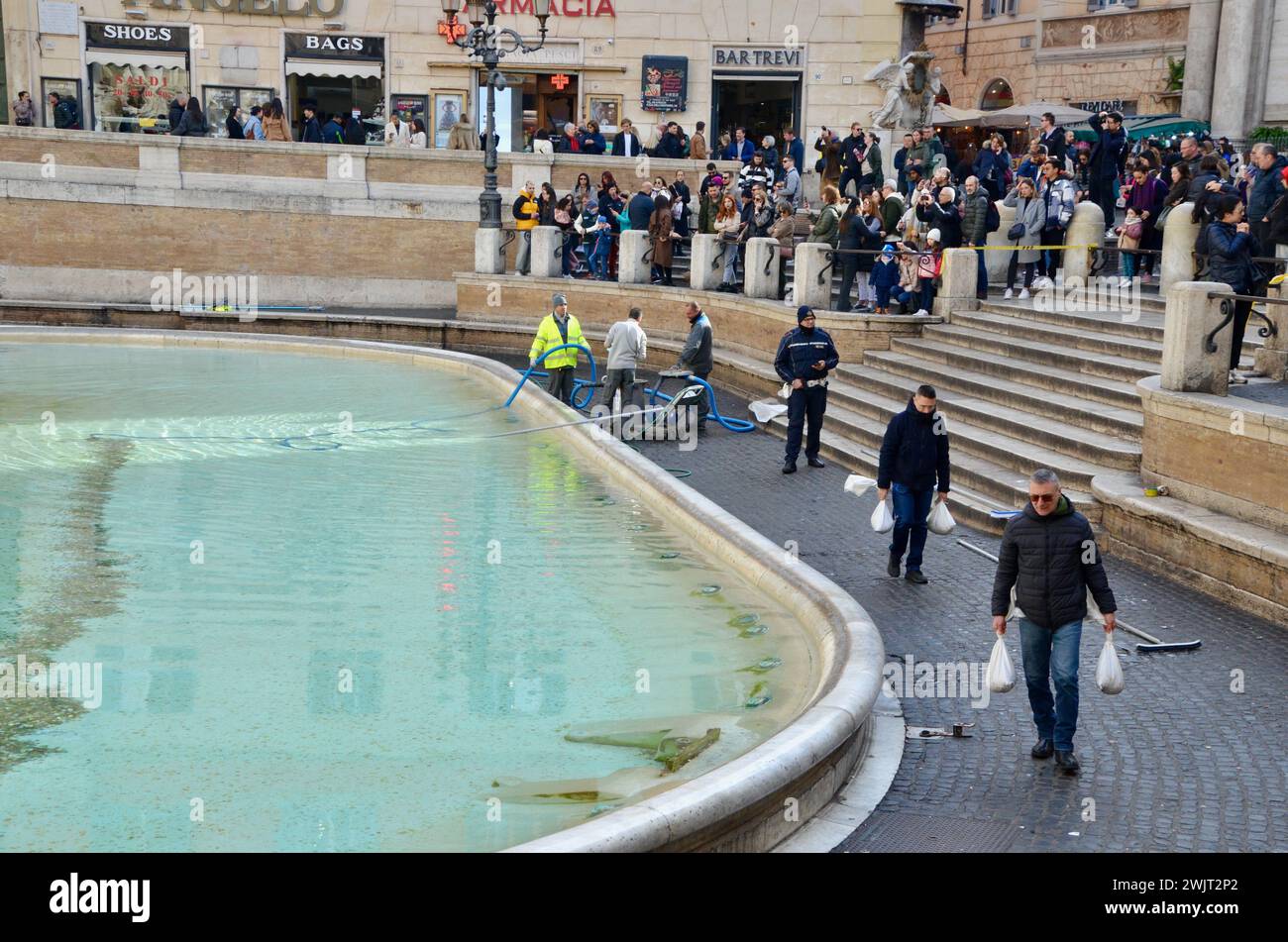 men collecting the money thrown into the trevi fountain rome capital of ...