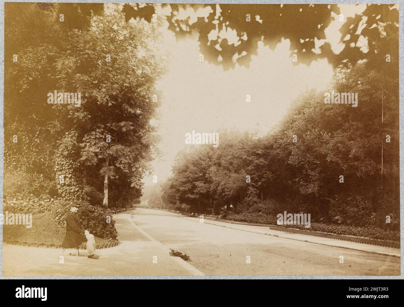 Man in uniform seated along a road, wood surrounding Paris. Anonymous ...