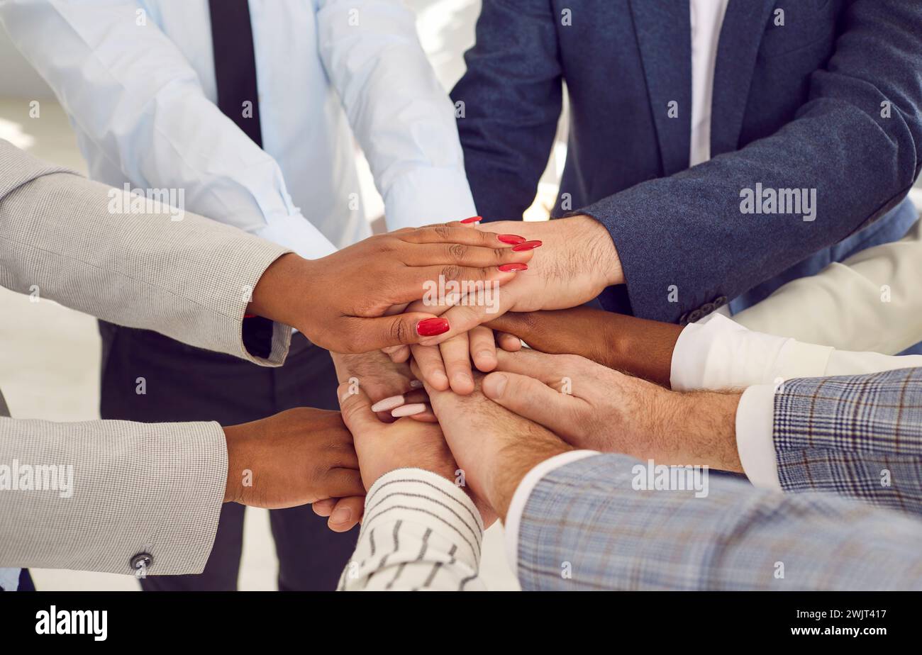 Close up top view photo of diverse business people putting their arms ...
