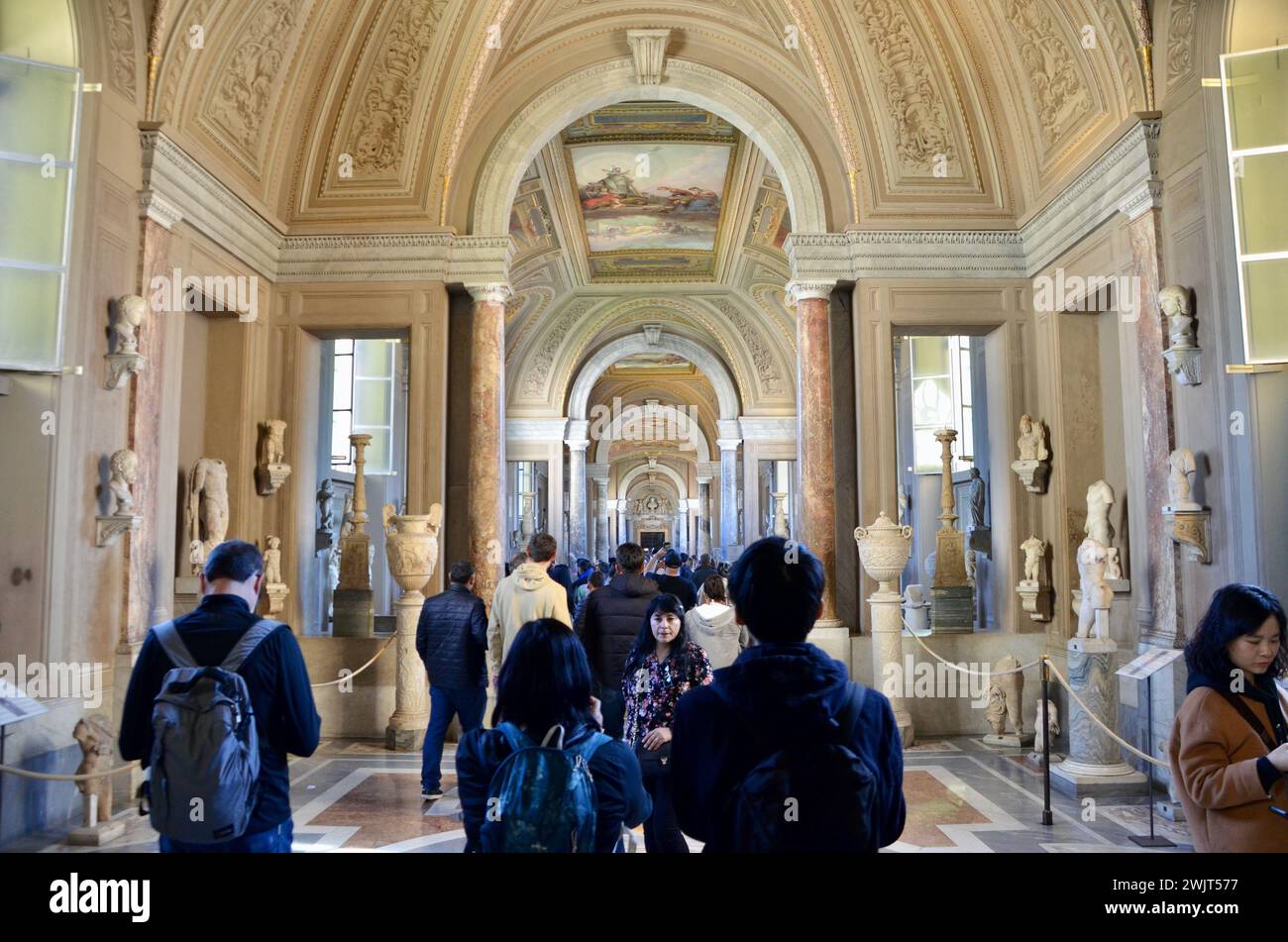 statue lined corridor full of tourists in vatican city rome capital of ...
