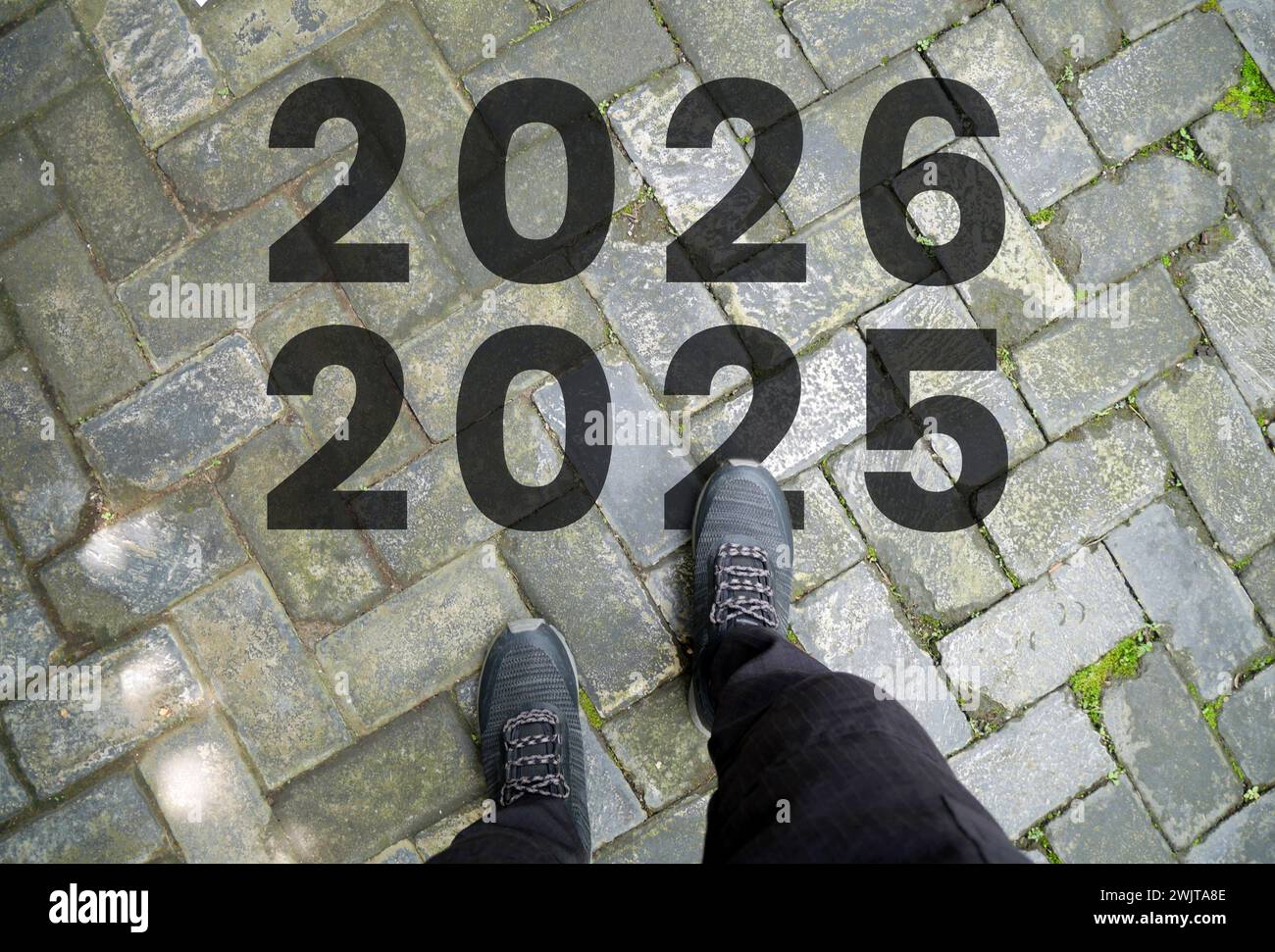 The text 2025 is written on the brick road and the male runner prepares ...
