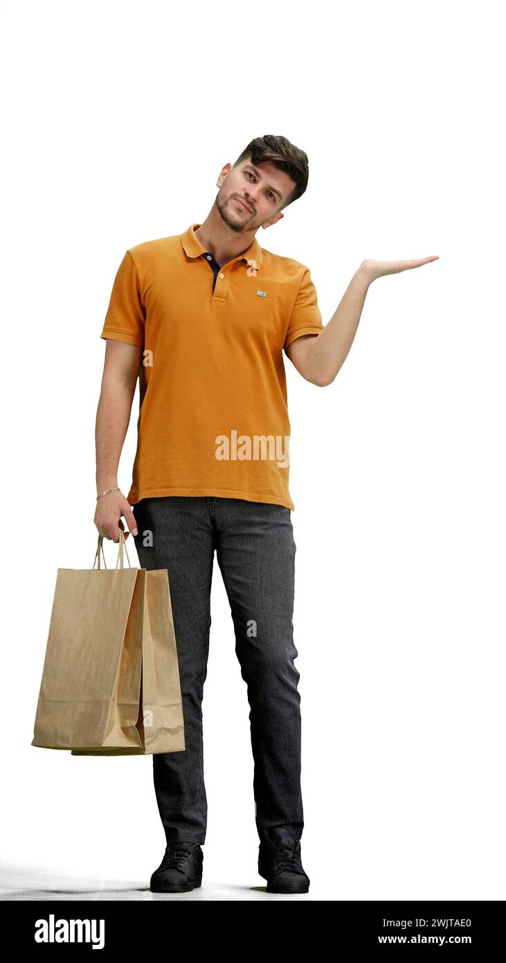A man, full-length, on a white background, with bags, points to the ...