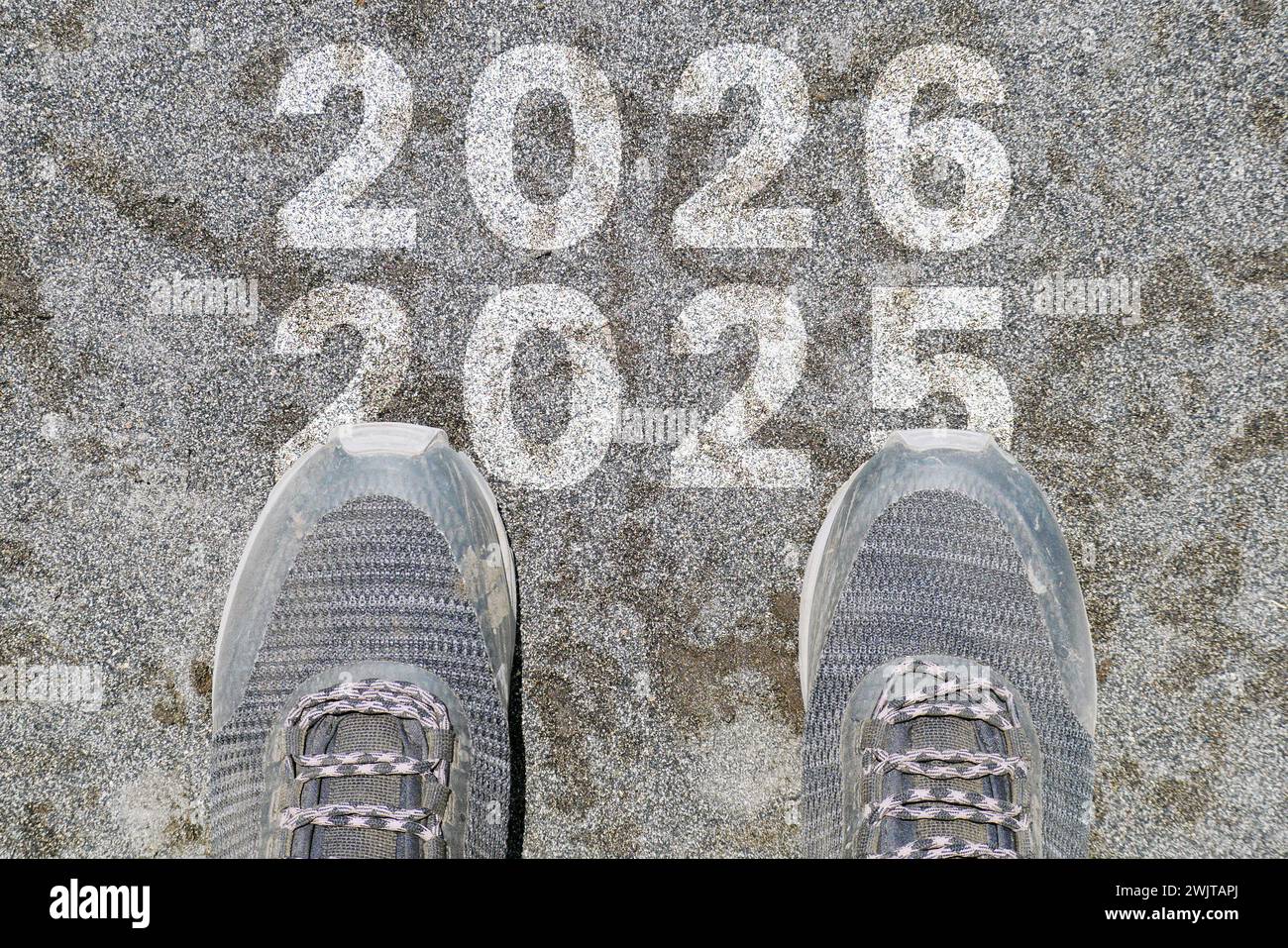 The text 2025 is written on the brick road and the male runner prepares ...