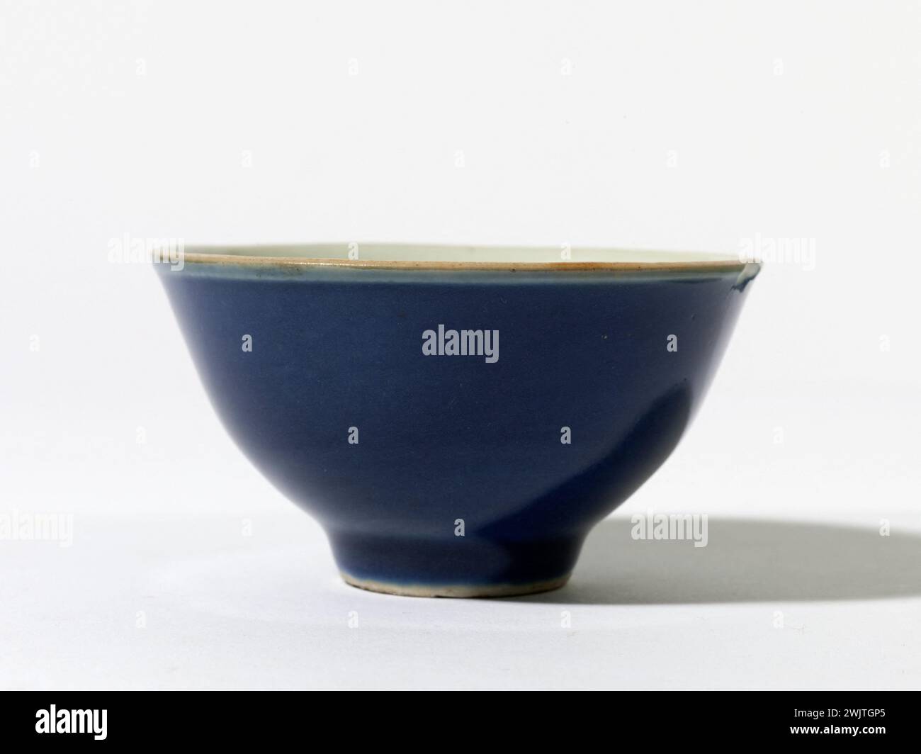Bowl. Blue covered porcelain enhanced with gilding on the outside and ...