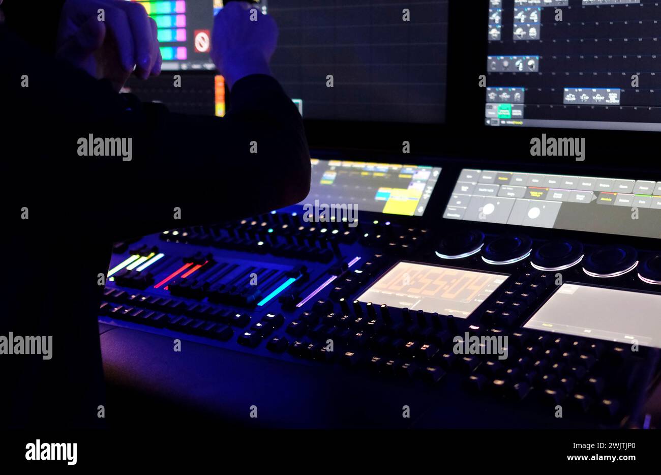 Backstage area at a convention with technical staff handling light and ...