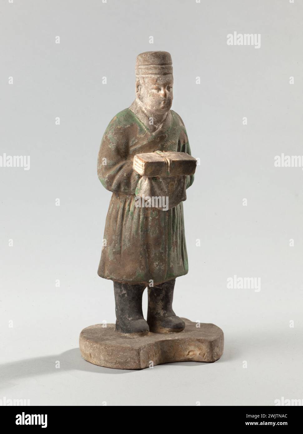 Male character mingqi. Terracotta, traces of green glaze; dark brown ...