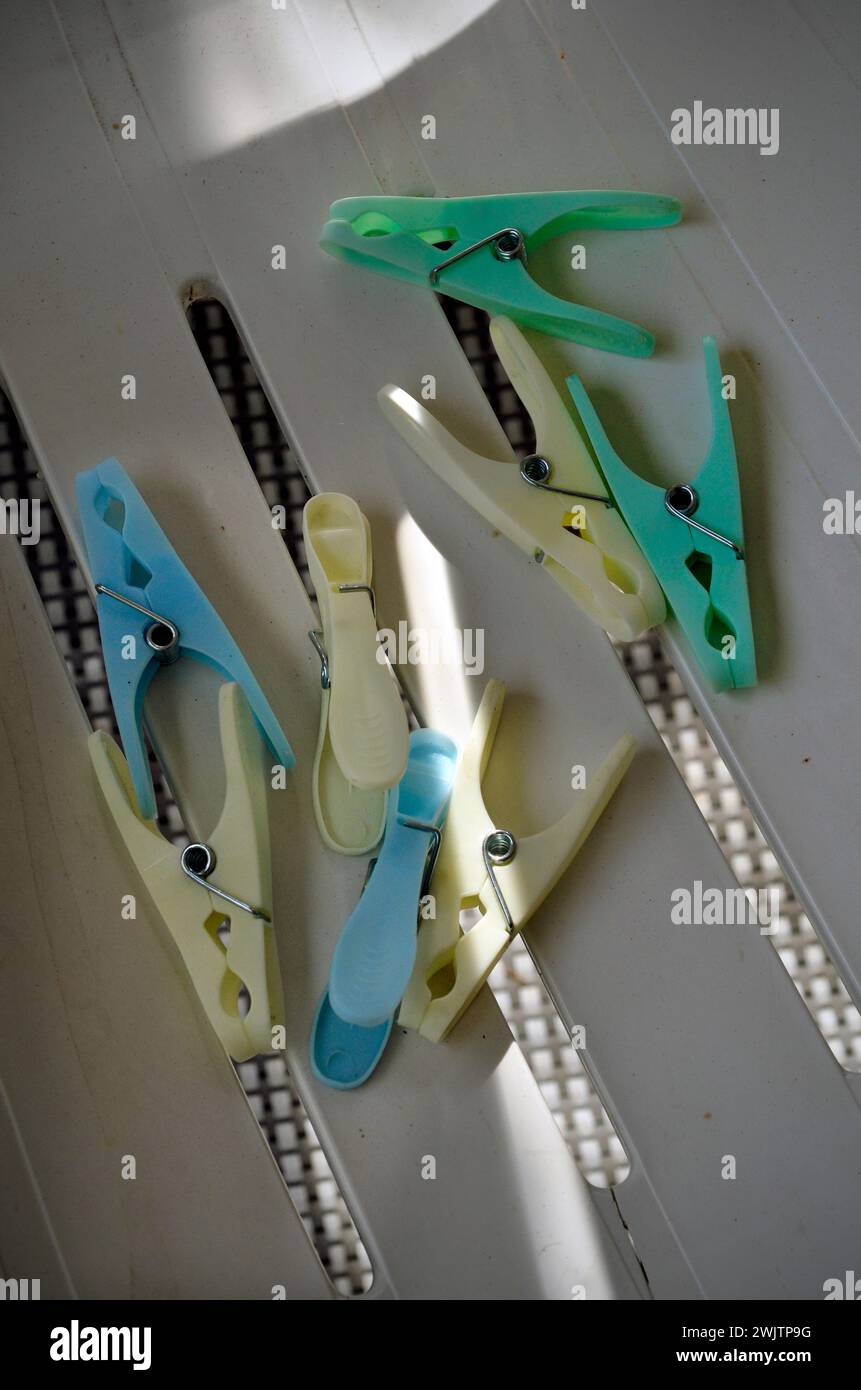 plastic clothes pegs laying on plastic garden chair seat Stock Photo ...