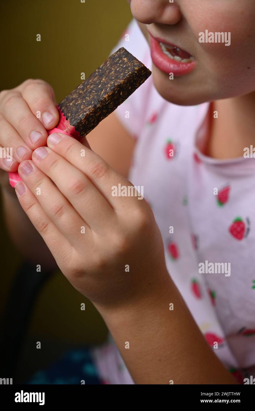 Young girl - child eating candy and sweets. Detail of face and mouth ...