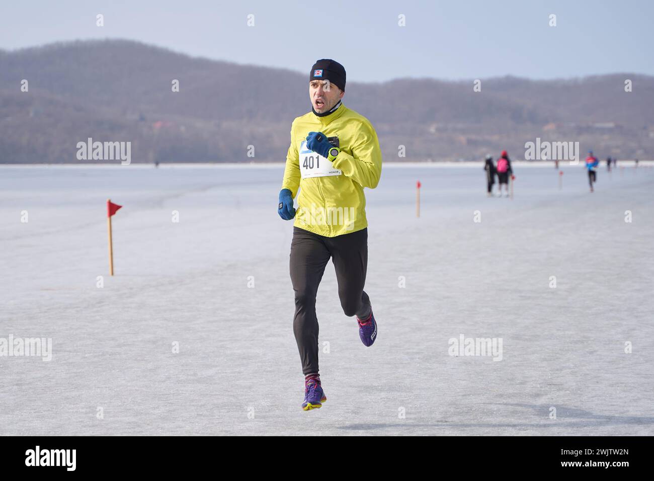 Vladivostok, Russia. 17th Feb, 2024. A man runs to the finishing line ...