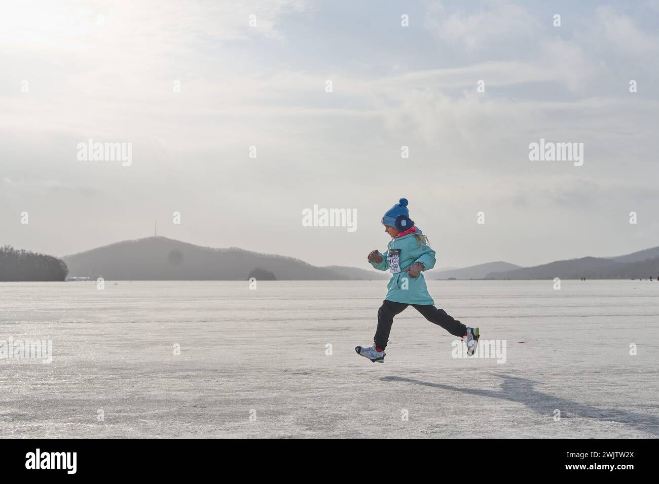 Vladivostok, Russia. 17th Feb, 2024. A girl runs during the "Ice Run" Half Marathon held on the ...