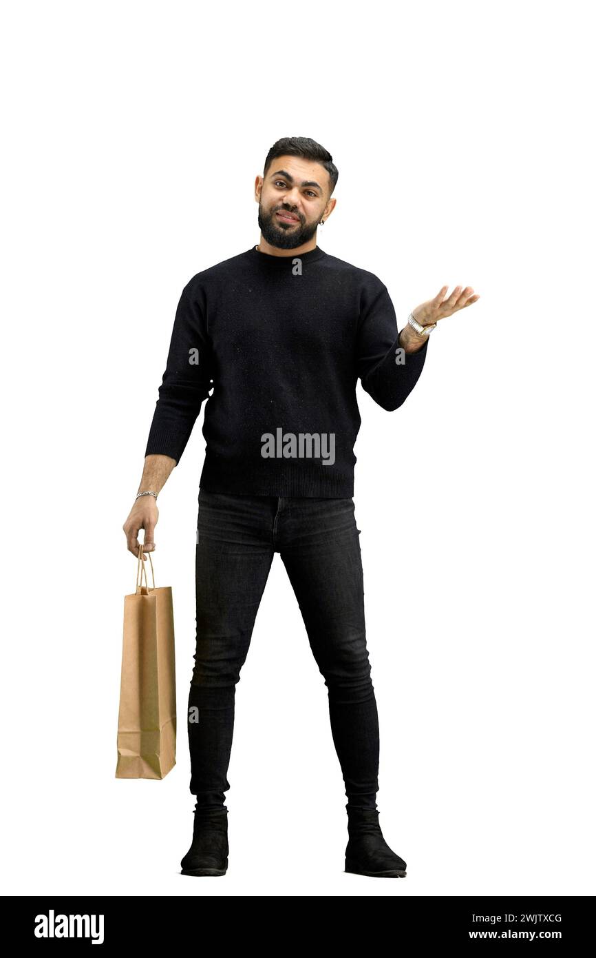 A man, full-length, on a white background, with bags, points to the ...