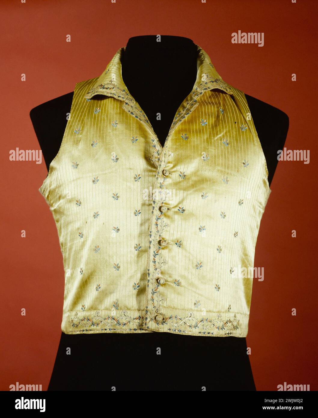 Vest. Yellow silk broachus with a sowing of pink and blue patterns, border, back and lining in ...