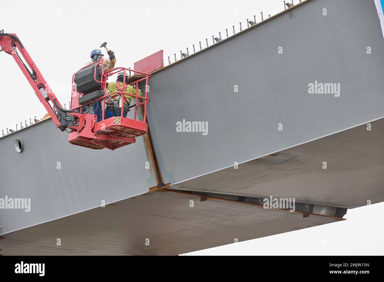 Hamburg, Germany. 17th Feb, 2024. Workers on a lifting platform set up ...