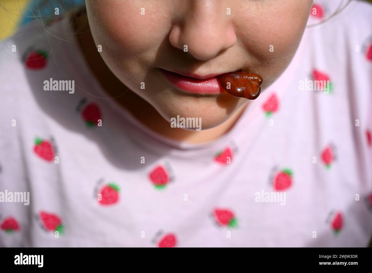 Young girl - child eating candy and sweets. Detail of face and mouth ...