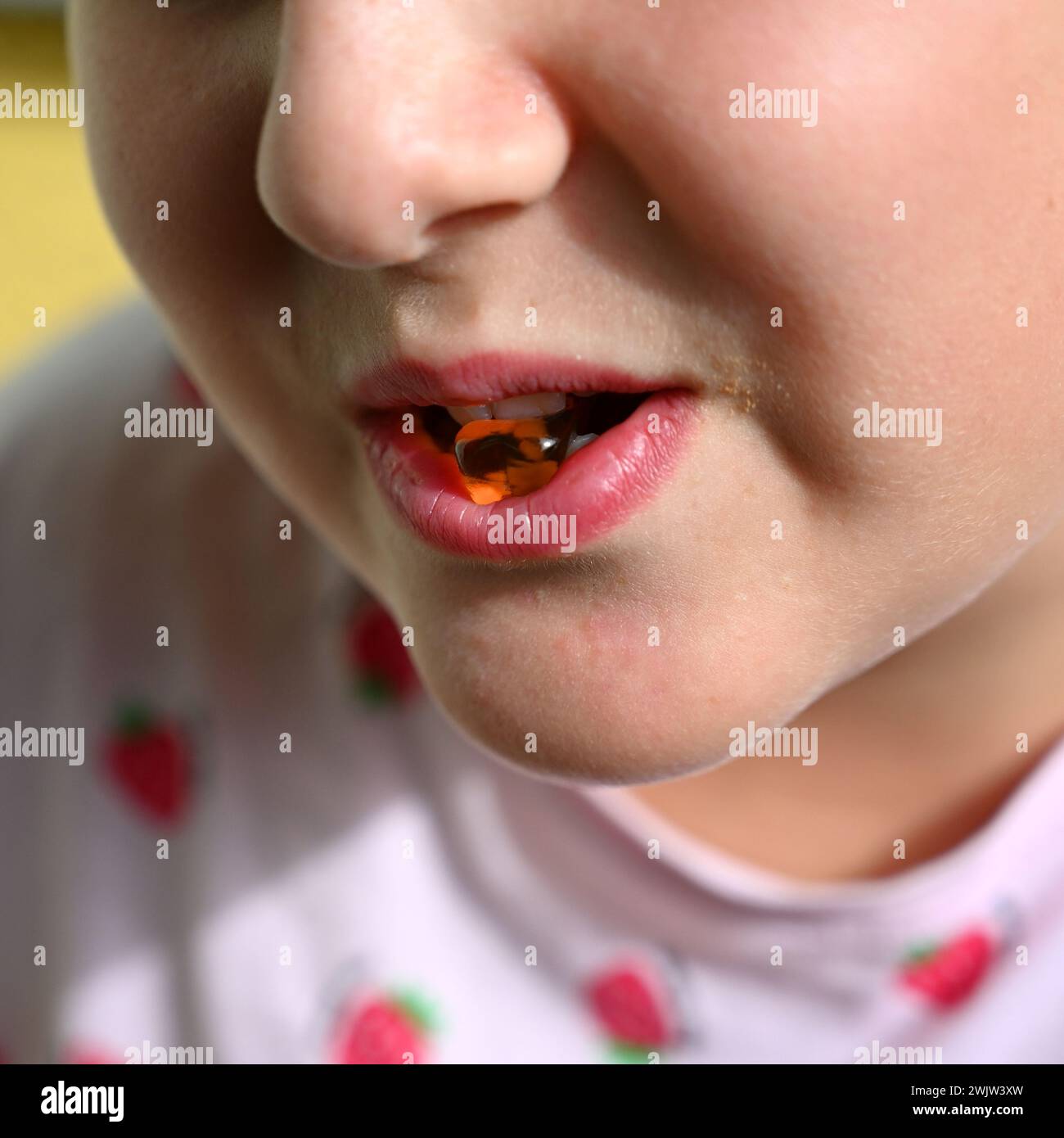 Young girl - child eating candy and sweets. Detail of face and mouth ...