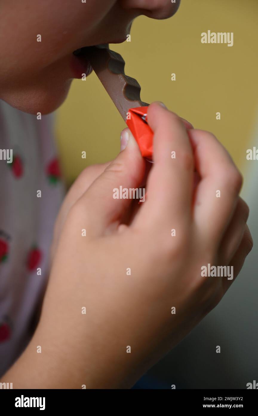 Young girl - child eating candy and sweets. Detail of face and mouth ...