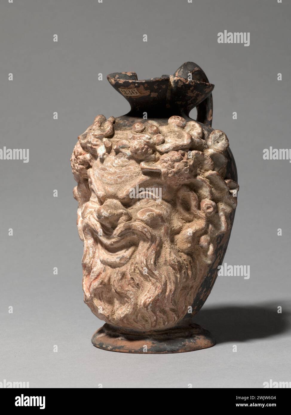 Oenochoe in the shape of a Silene head. Molded terracotta, tower ...