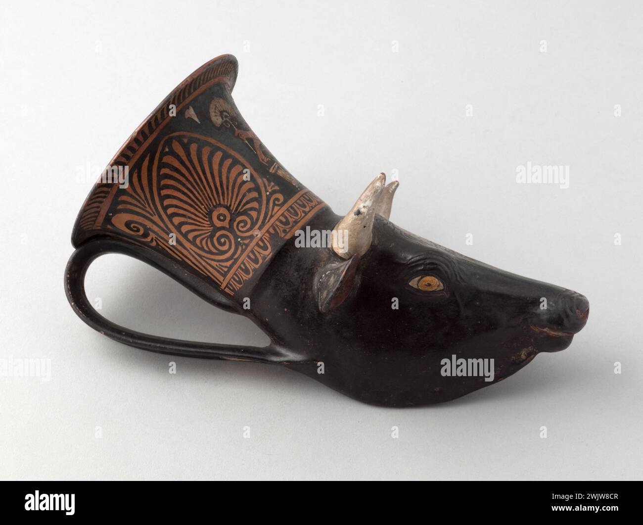 Group of menzies. Rhyton in the shape of a cow's head. Red figures ...