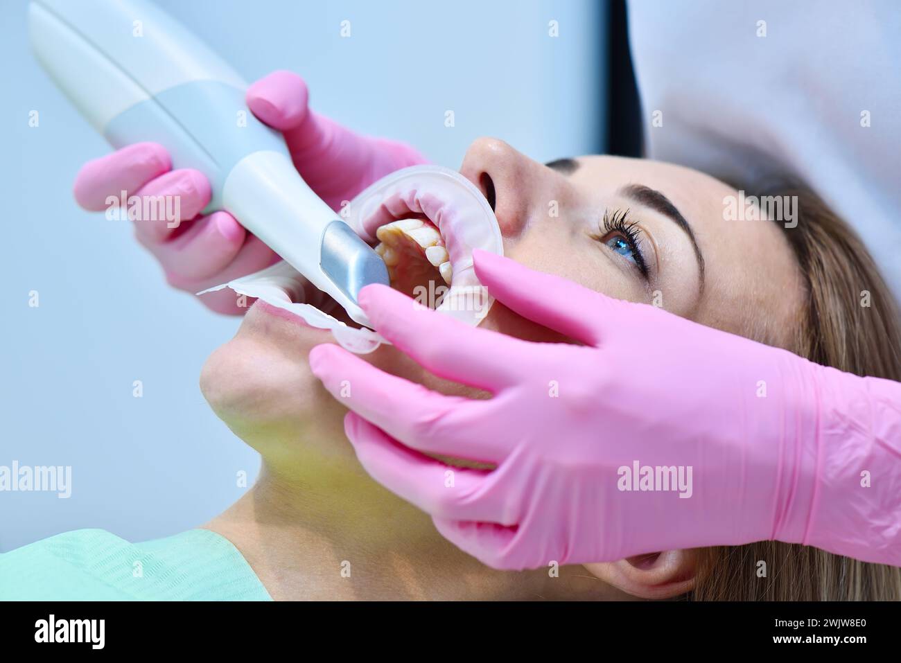 Hands dentist doing 3d scanning of patients teeth. Checkup and ...
